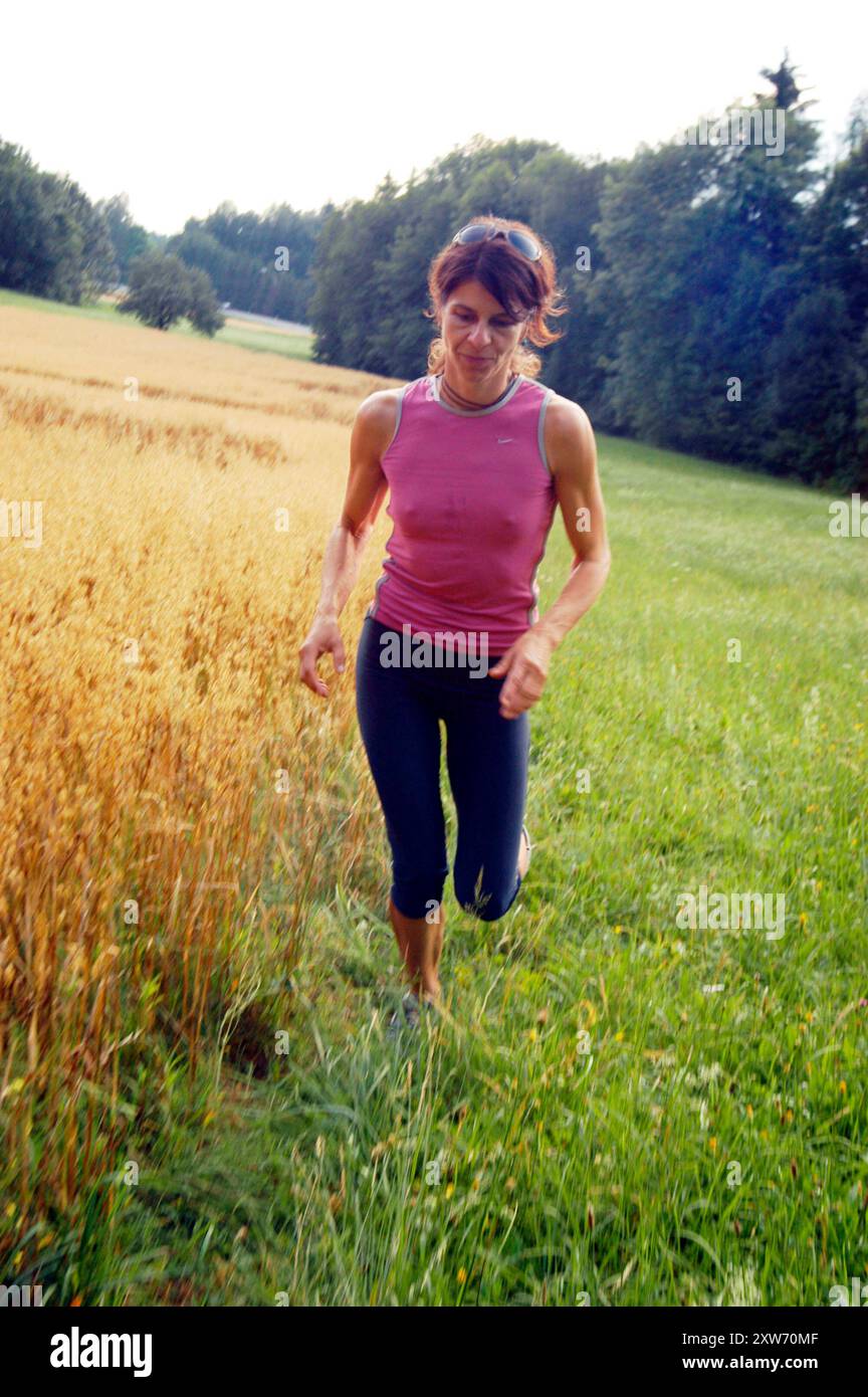 female runner in sports clothes with sunglasses on her head, from above ...