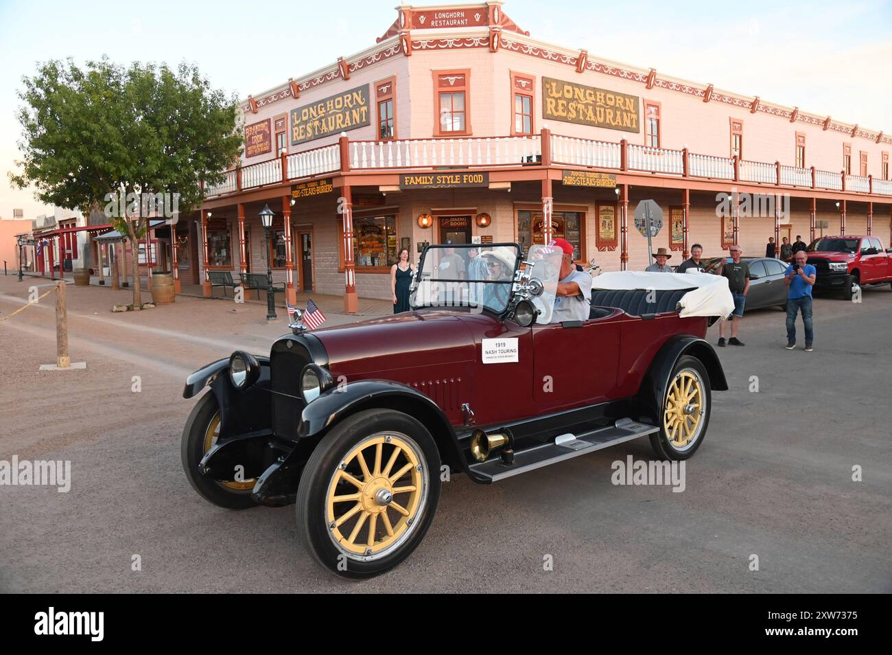 USA. ARIZONA. TOMBSTONE. OLD CAR PASSING BY THE LONGHORN RESTAURANT ...