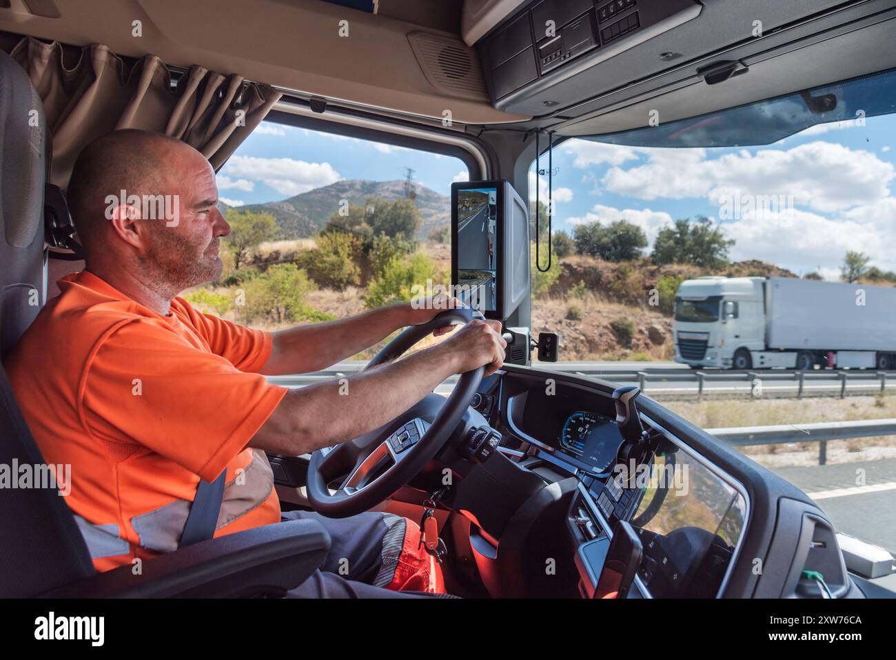 Trucker in the truck seat, concentrating on monotonous driving on a ...