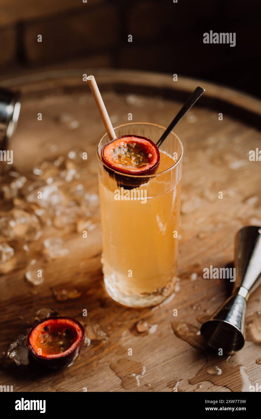 Refreshing passion fruit cocktail in highball glass, for summer vibes and tropical-themed events ...