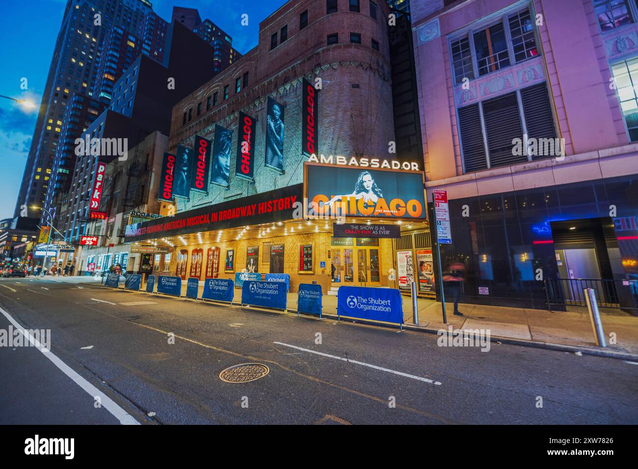 Night view of New York City with the Ambassador Theatre showcasing the ...