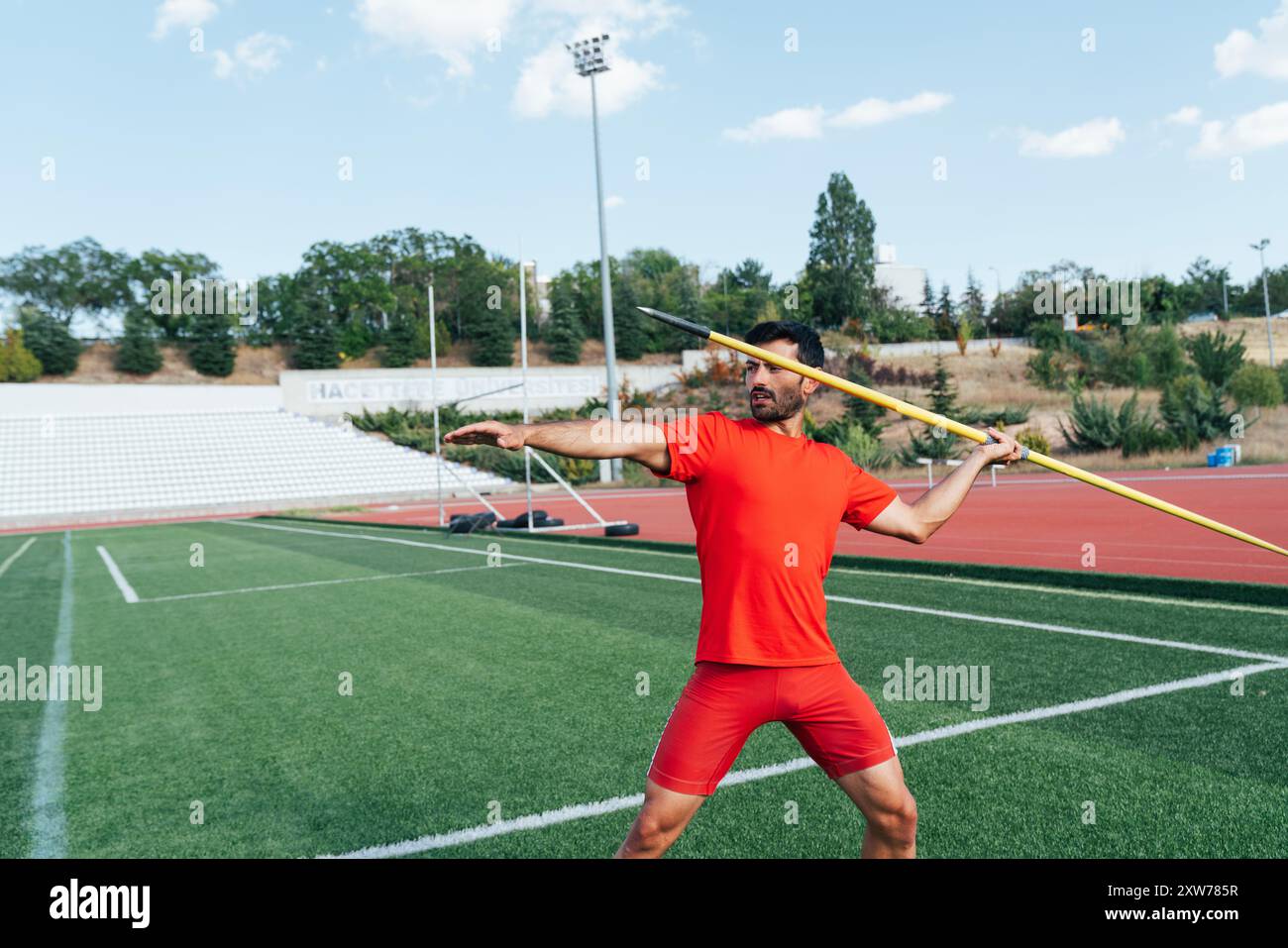 An athletic man throws the javelin in the stadium Stock Photo - Alamy