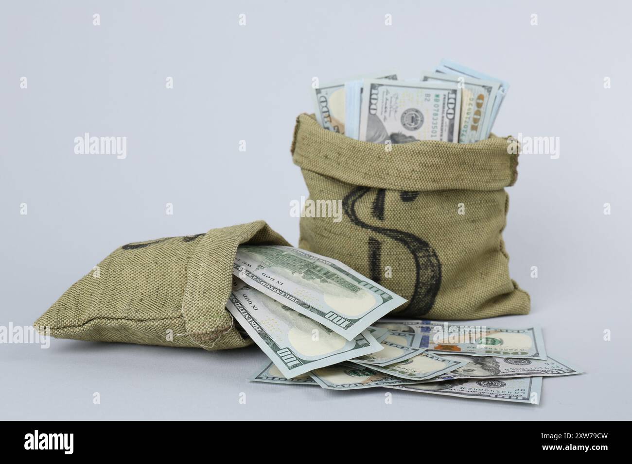 Dollar banknotes in bags on grey background Stock Photo - Alamy