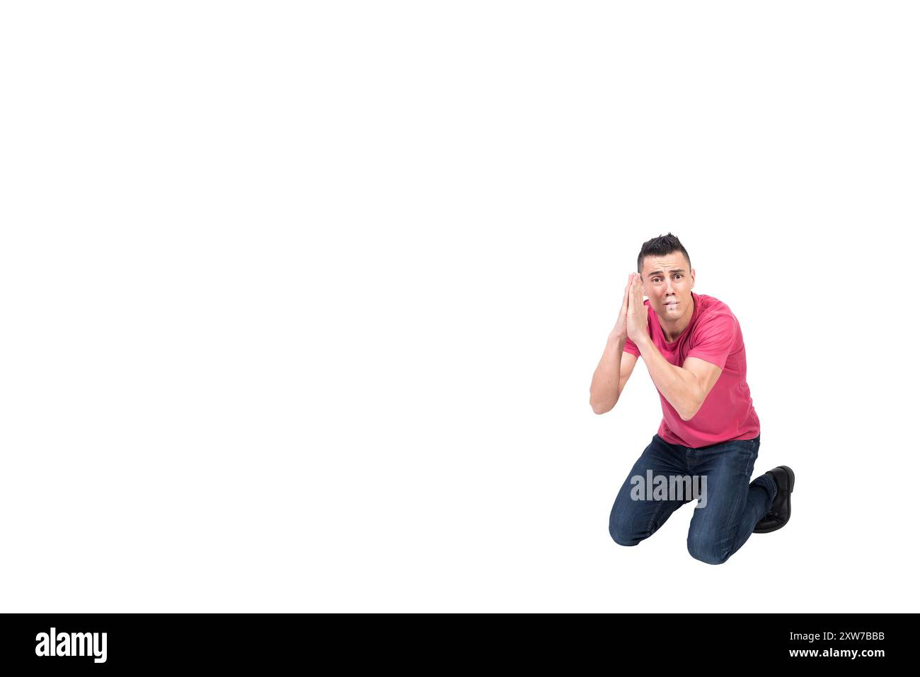 Desperate man kneeling and supplicating with prayer hands Stock Photo ...