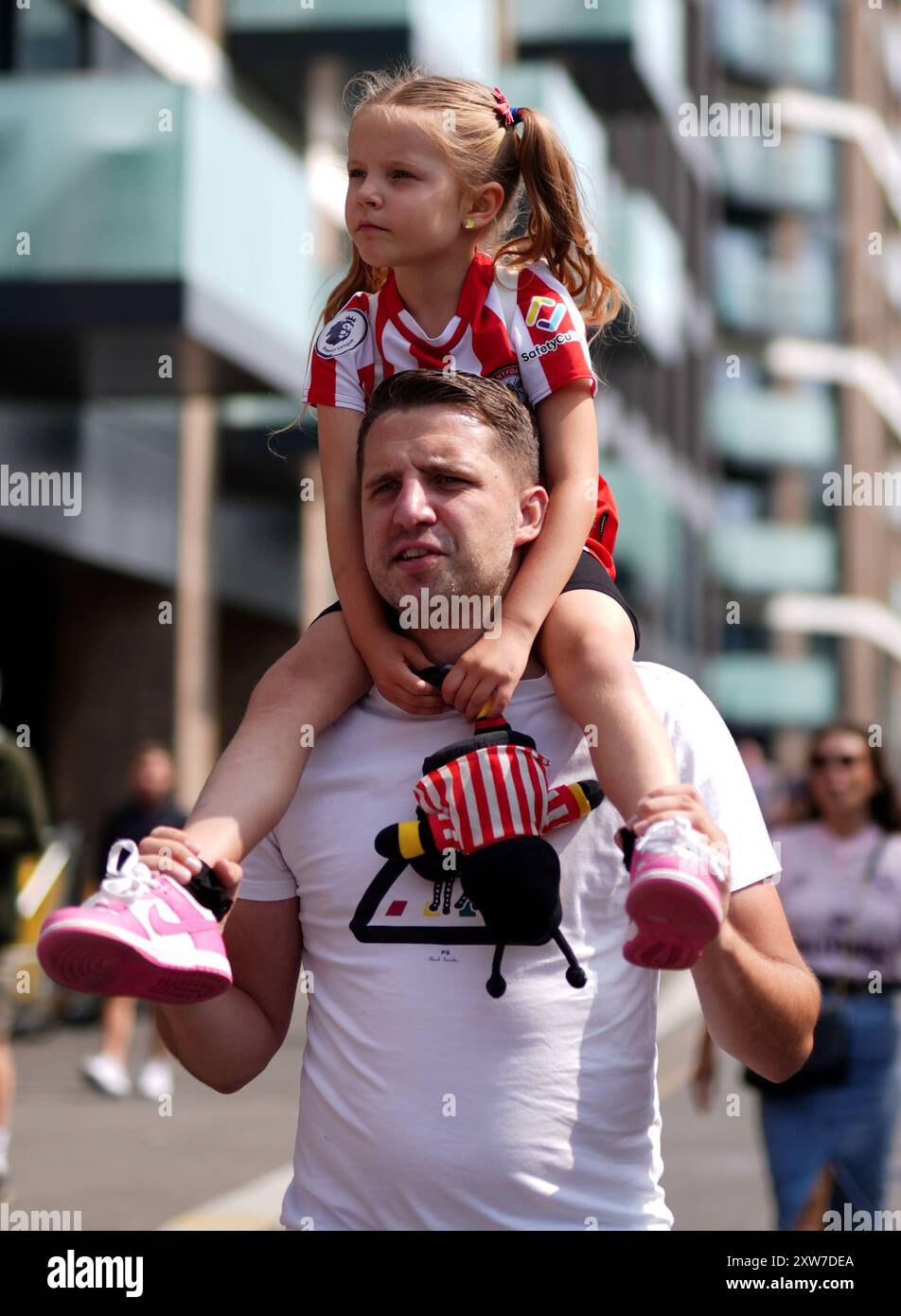 Brentford fans arrive at the ground ahead of the Premier League match ...