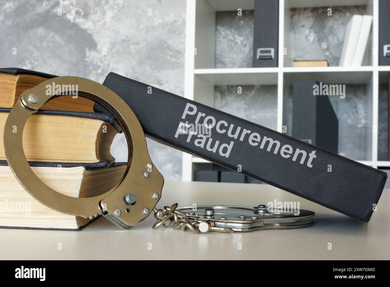 Books about procurement fraud and handcuffs. Legal consequences concept ...