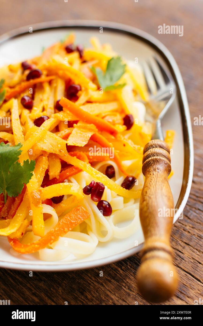 Sautéed Carrots and Rutabaga on Pasta with Pomegranate Sauce Stock ...