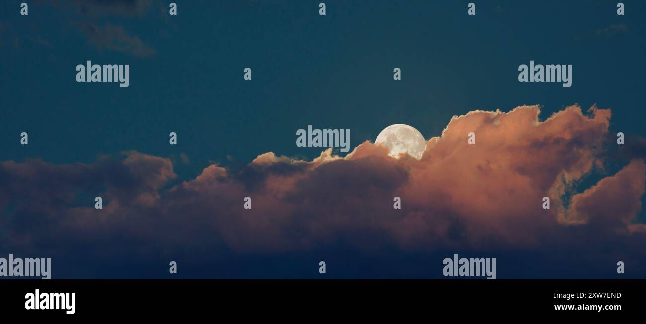 Bright moon rising from behind hi-res stock photography and images - Alamy