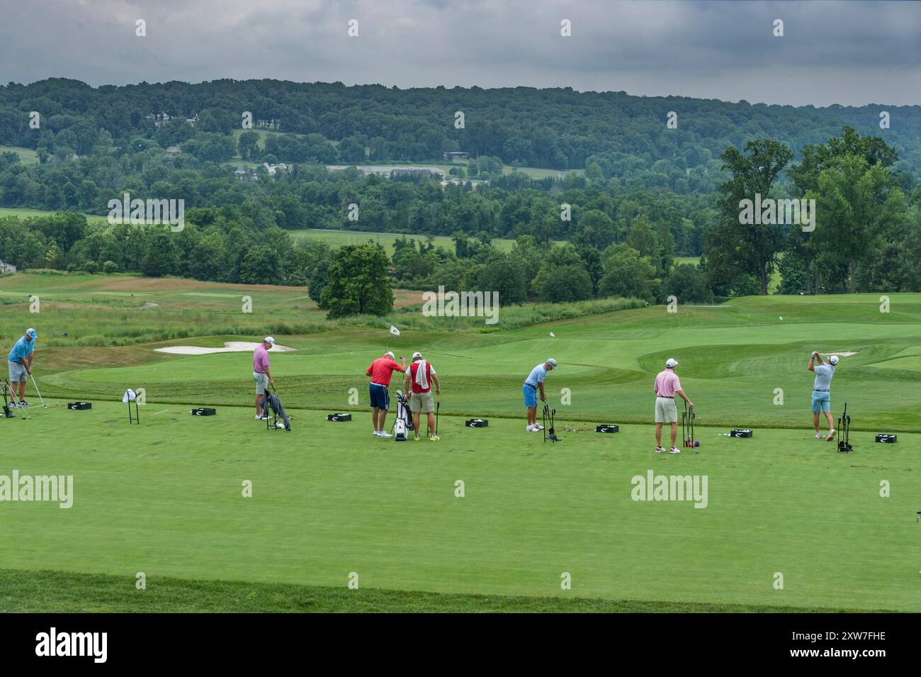 Men hitting golf balls on country club driving range, Pennsylvania, USA ...