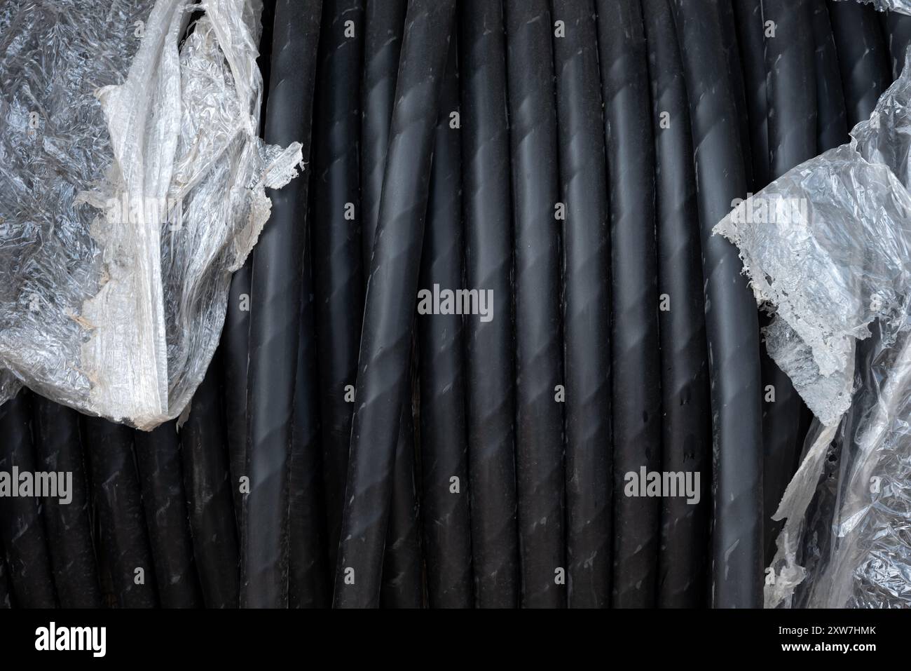 A bay of black electrical cable. Industrial cable Stock Photo - Alamy