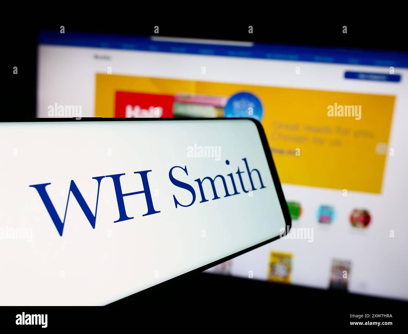 Cellphone with logo of British retail company WH Smith plc (WHSmith) in ...
