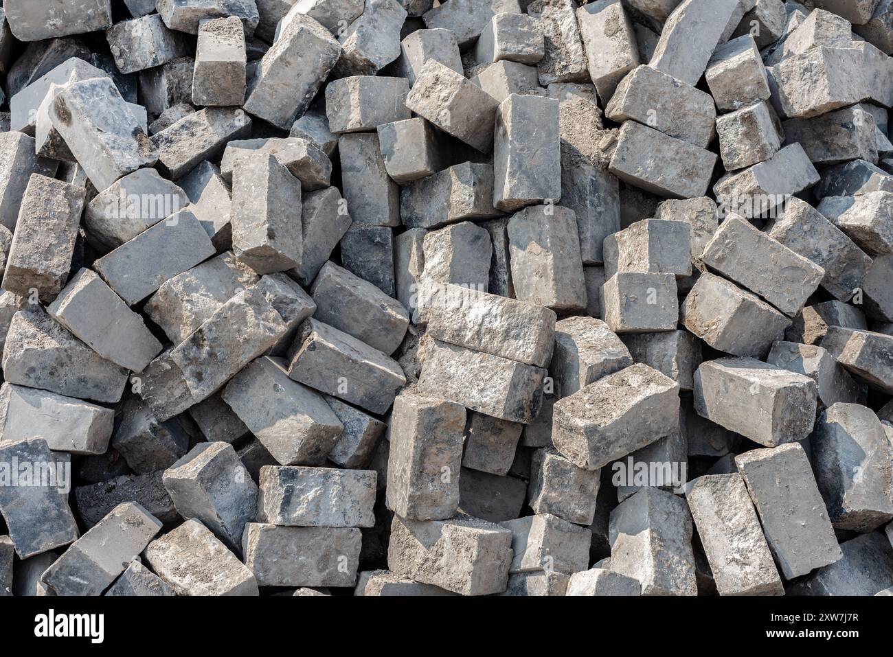 Background of gray whole and broken bricks. A pile of scattered bricks ...