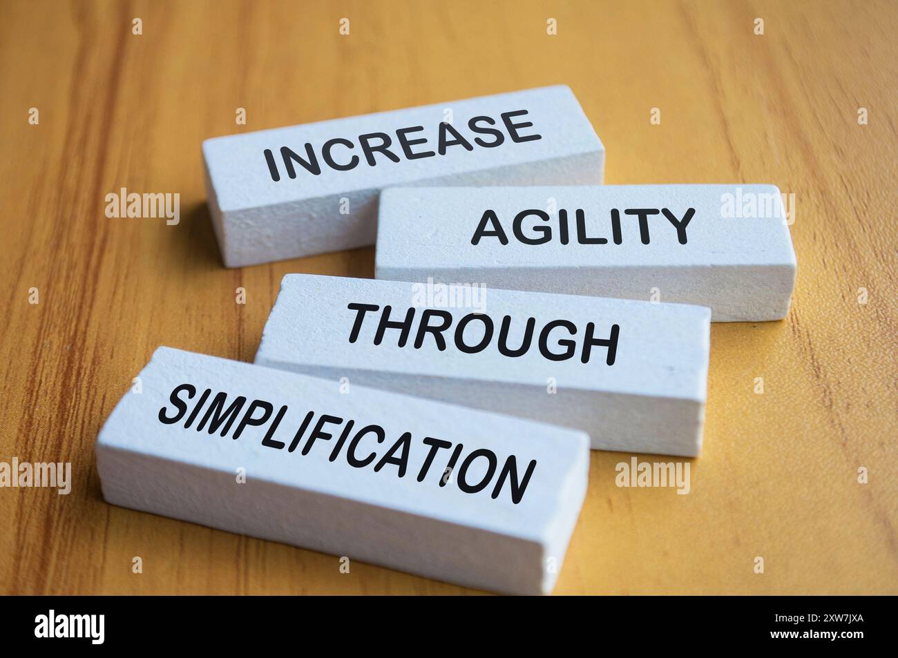 increase agility through simplification text on white wooden blocks ...