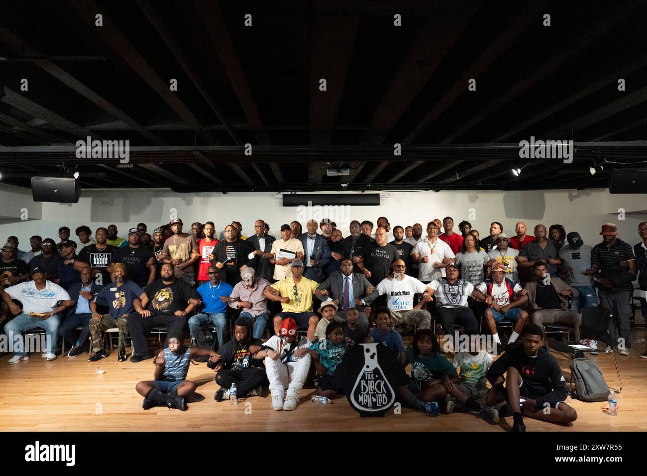 Attendees pose for photos after a Black Man Lab meeting to discuss the ...