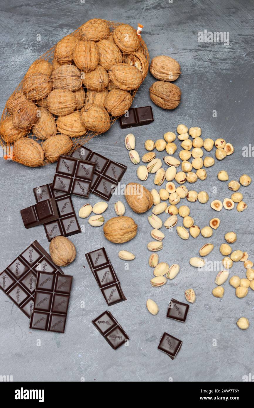 Chocolate bars, walnuts and hazelnuts on a gray background Stock Photo ...