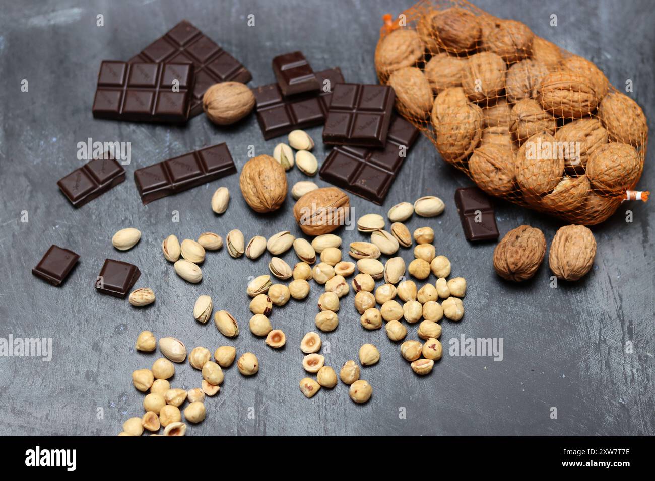 Homemade chocolate ingredients on a table. Nuts and chocolates close up ...