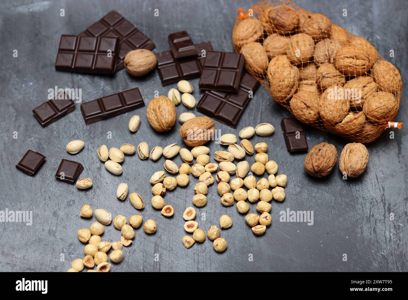 Different types of nuts on a table. Walnut, hazelnut, pistachio on grey ...