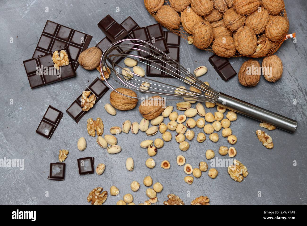 Homemade chocolate ingredients on a table. Nuts and chocolates close up ...