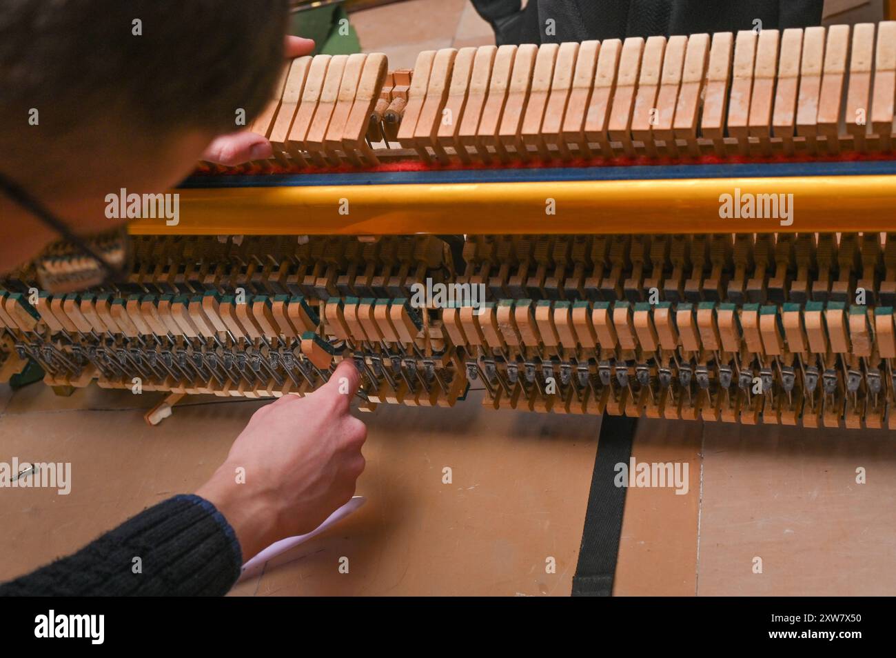 The tuner tunes the piano with instrument Stock Photo - Alamy