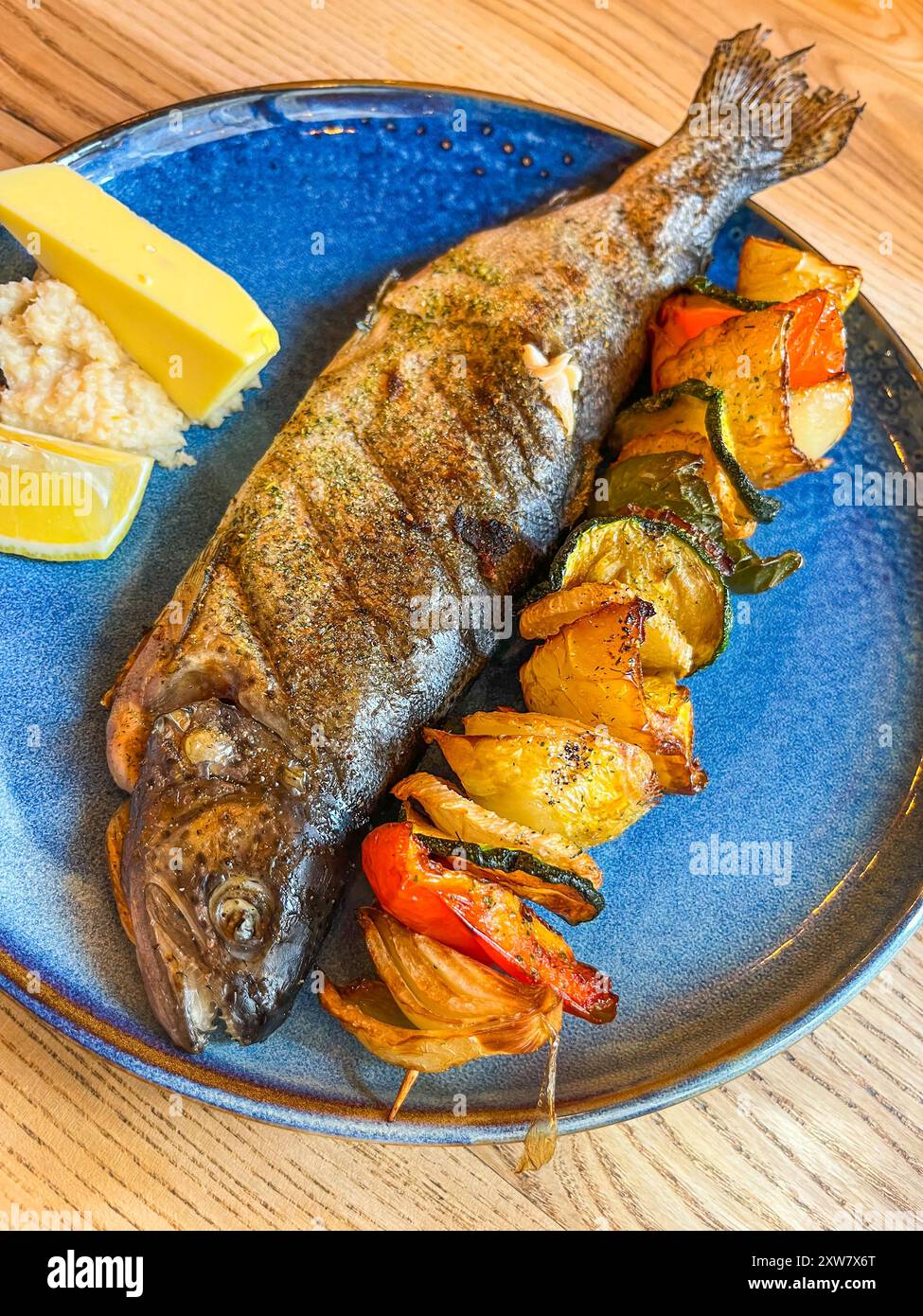 fried fish with a vegetable kebab. vertical Stock Photo - Alamy