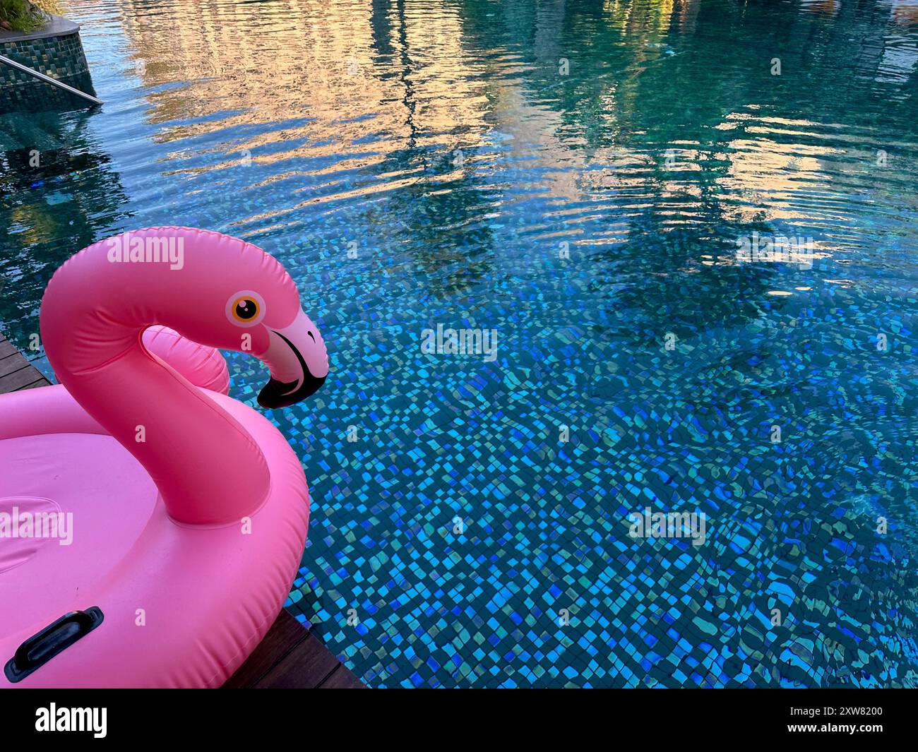 Outdoor swimming pool with clear water and inflatable float in shape of ...