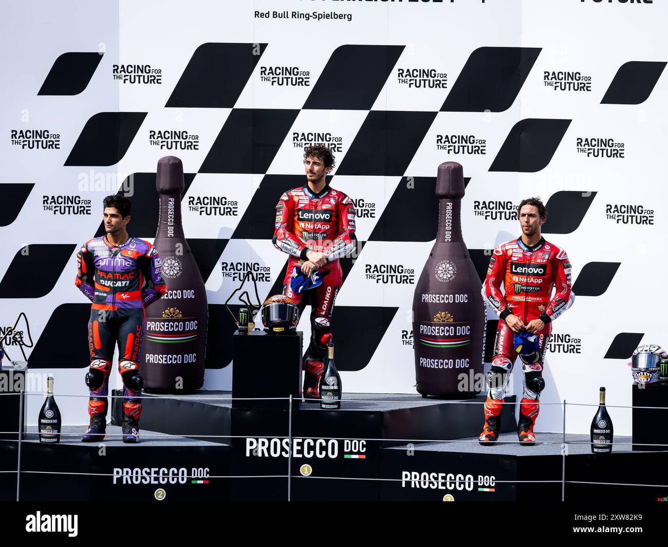 The three riders on the podium during the italian national anthem after ...