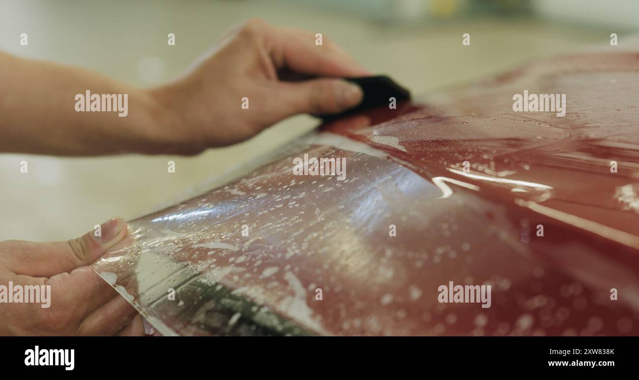 Professional applying protective film hi-res stock photography and ...