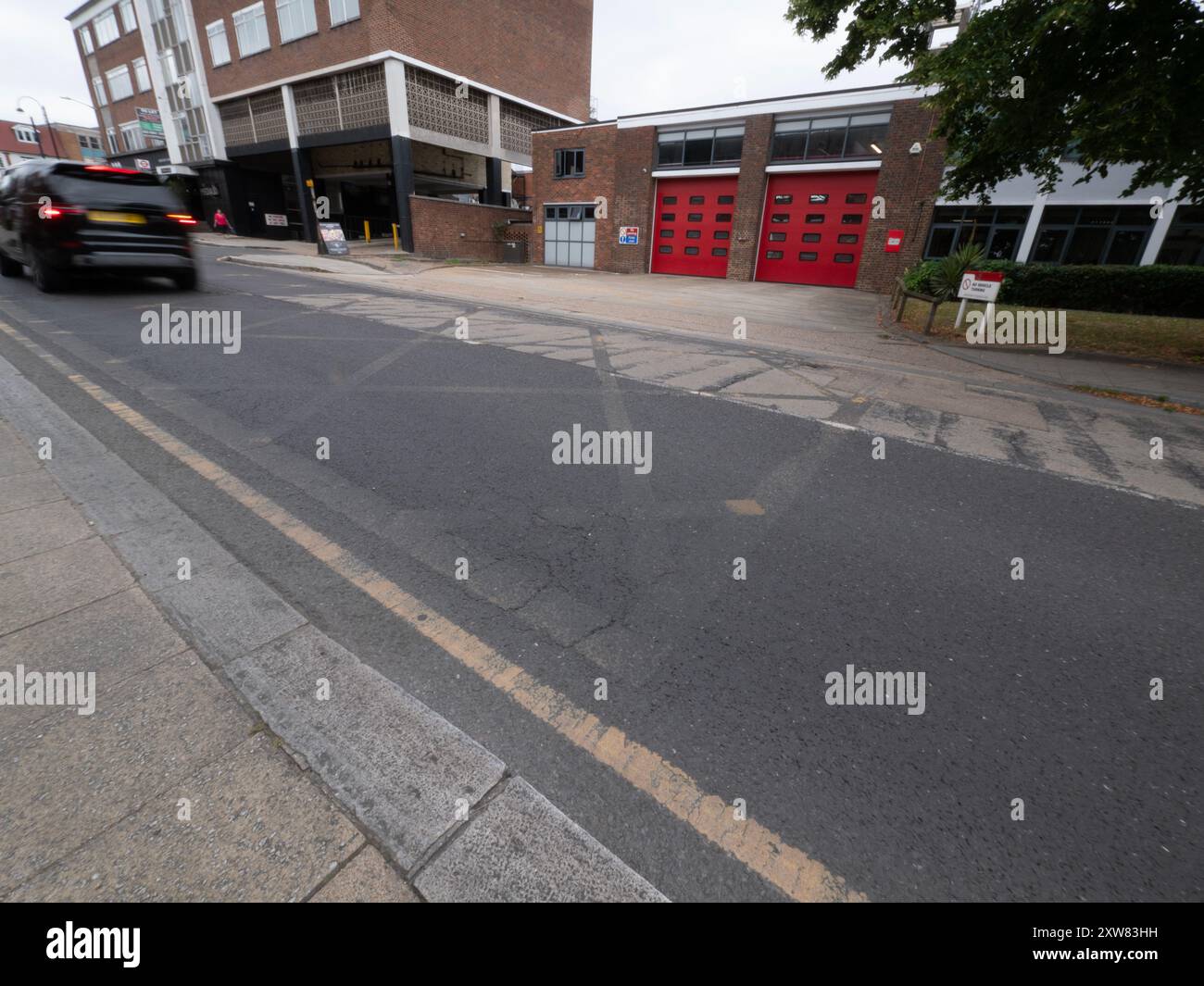 Faded and Worn box Junction outside fire station Loughton, Essex Stock ...