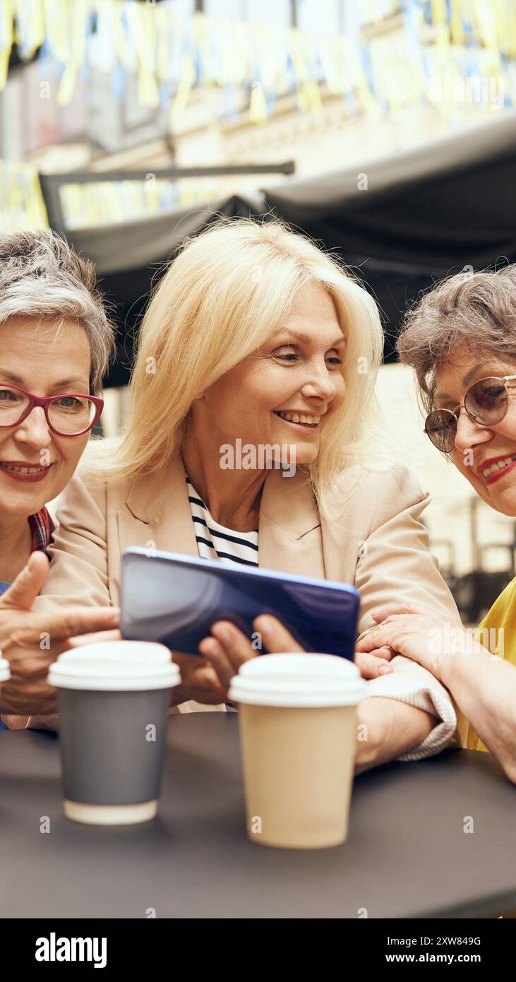 Joyful mature lady using smartphone hi-res stock photography and images ...