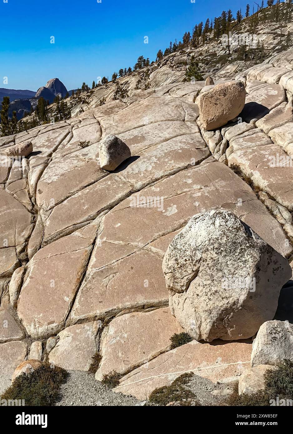 Erosion lines and boulders create patterns on a granite hillside along ...
