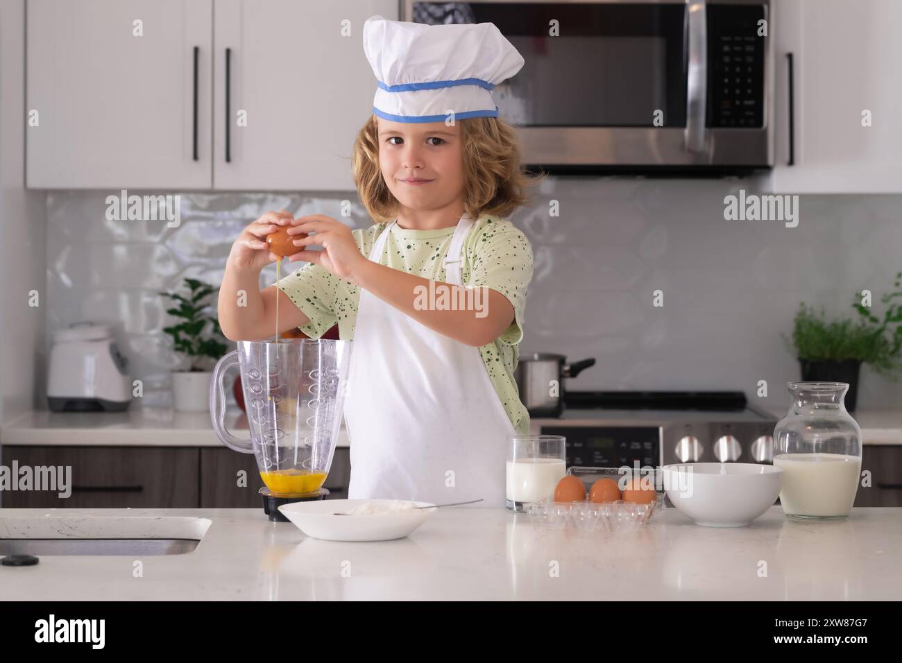 Funny kid chef cook cookery at kitchen. Chef kid boy making healthy ...