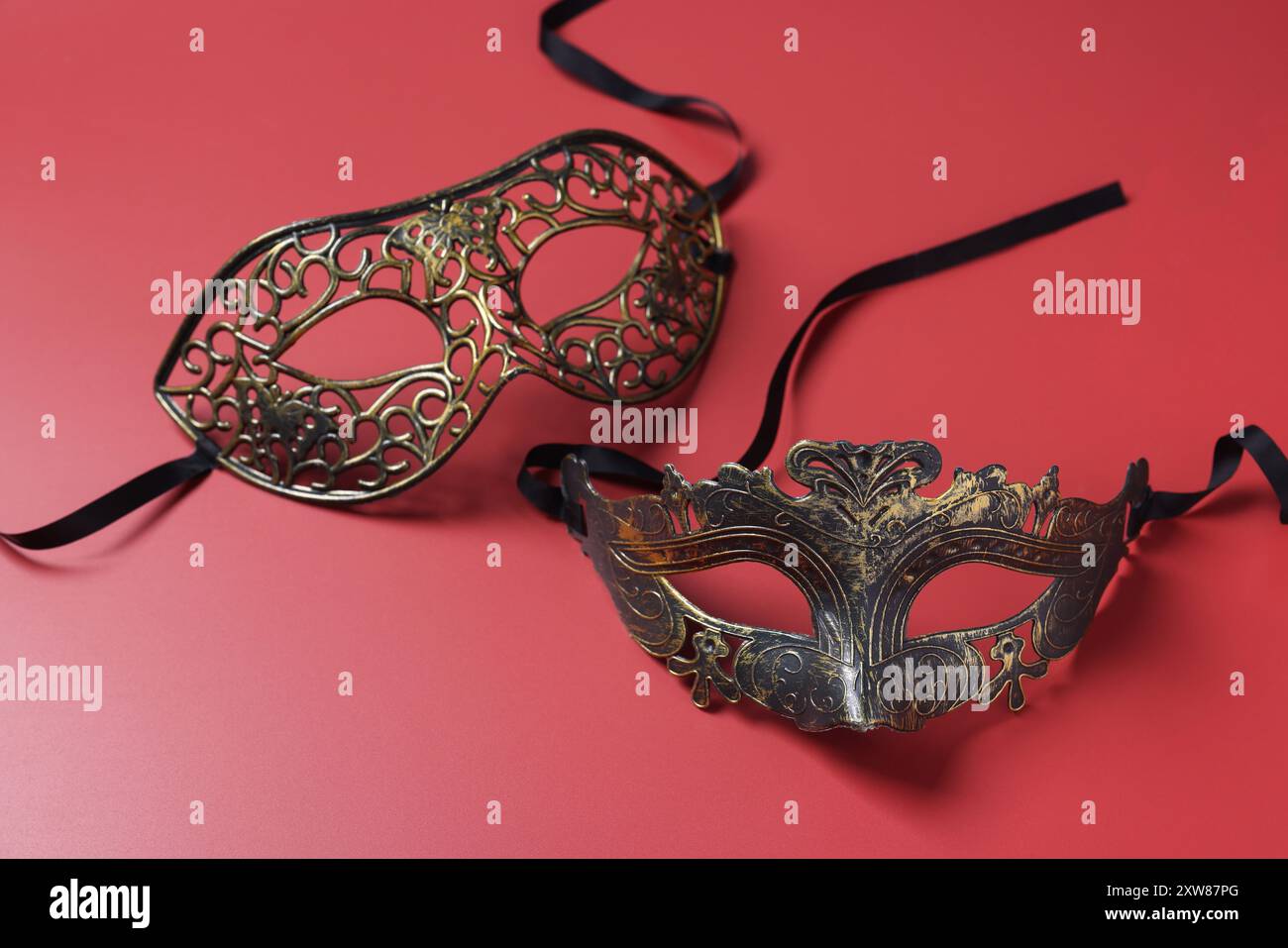 Two beautiful carnival masks on red background Stock Photo - Alamy
