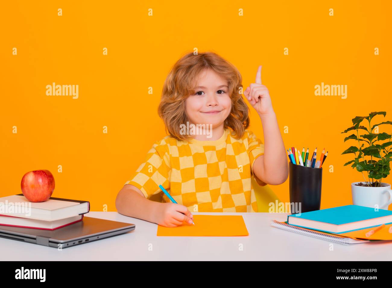 School kid holding index finger up with great new idea. Child from ...
