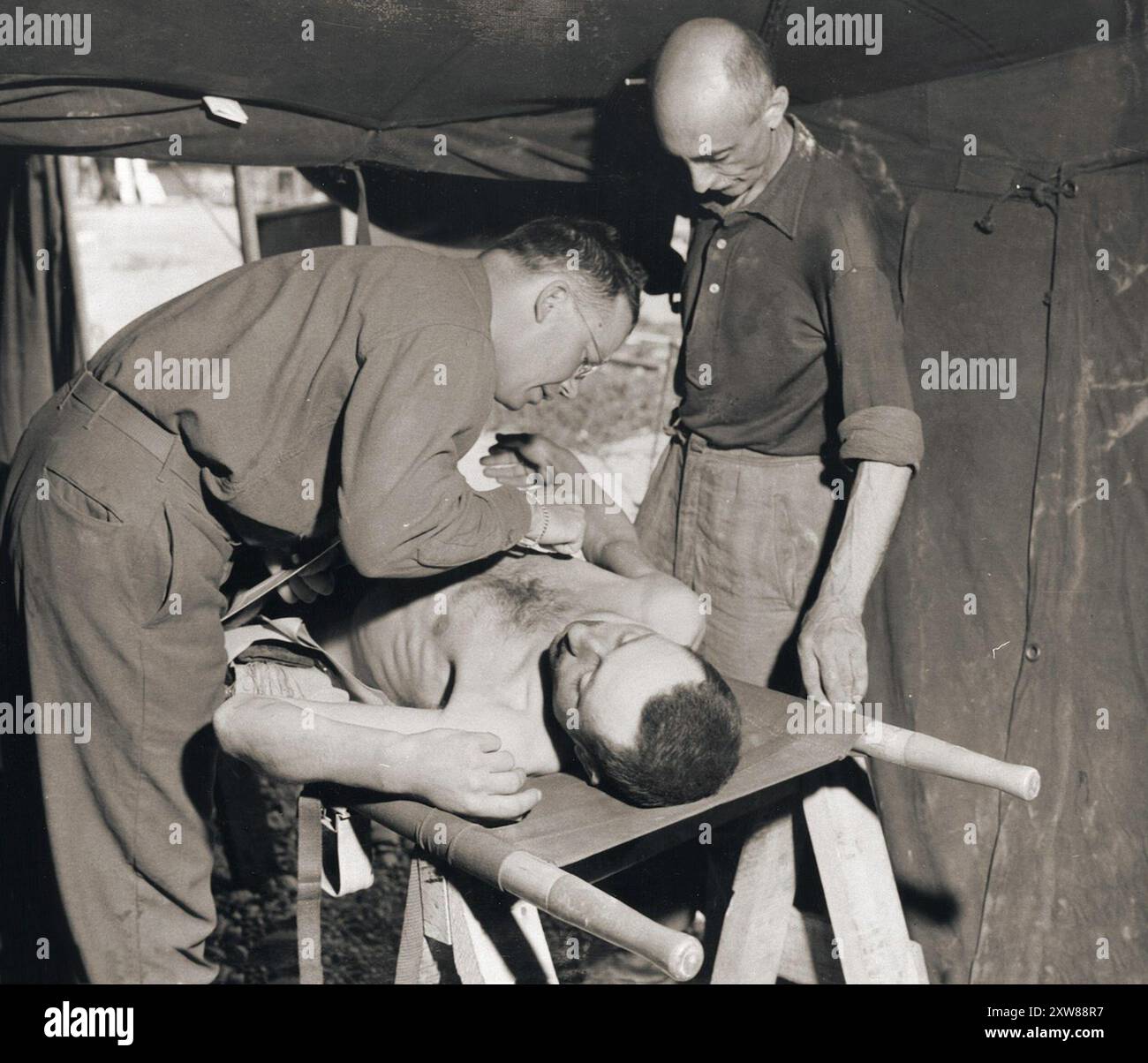 American army medics giving medical treatment to a emaciated ...