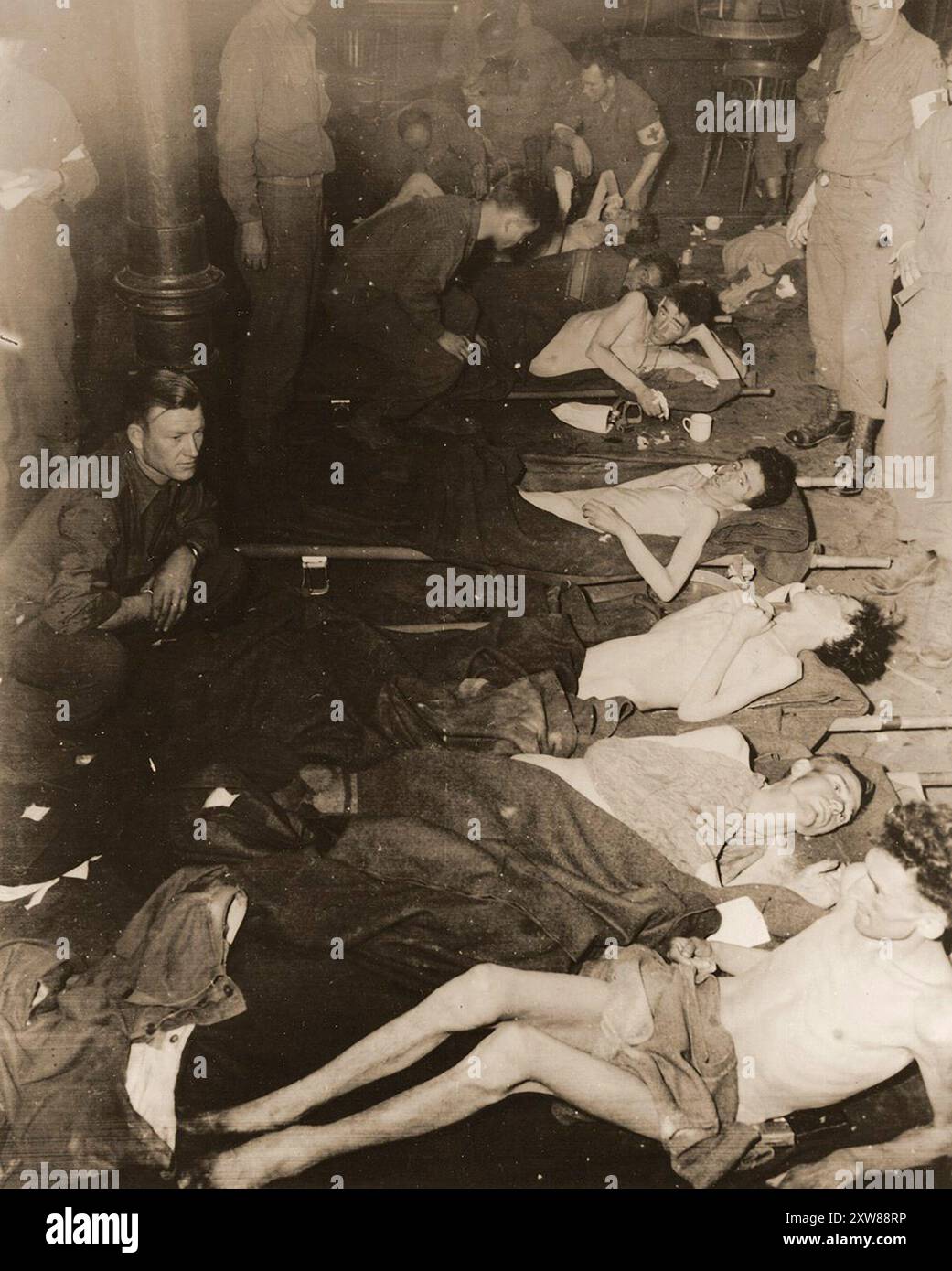 Emaciated American POWs being treated by American army medics. The 63 ...