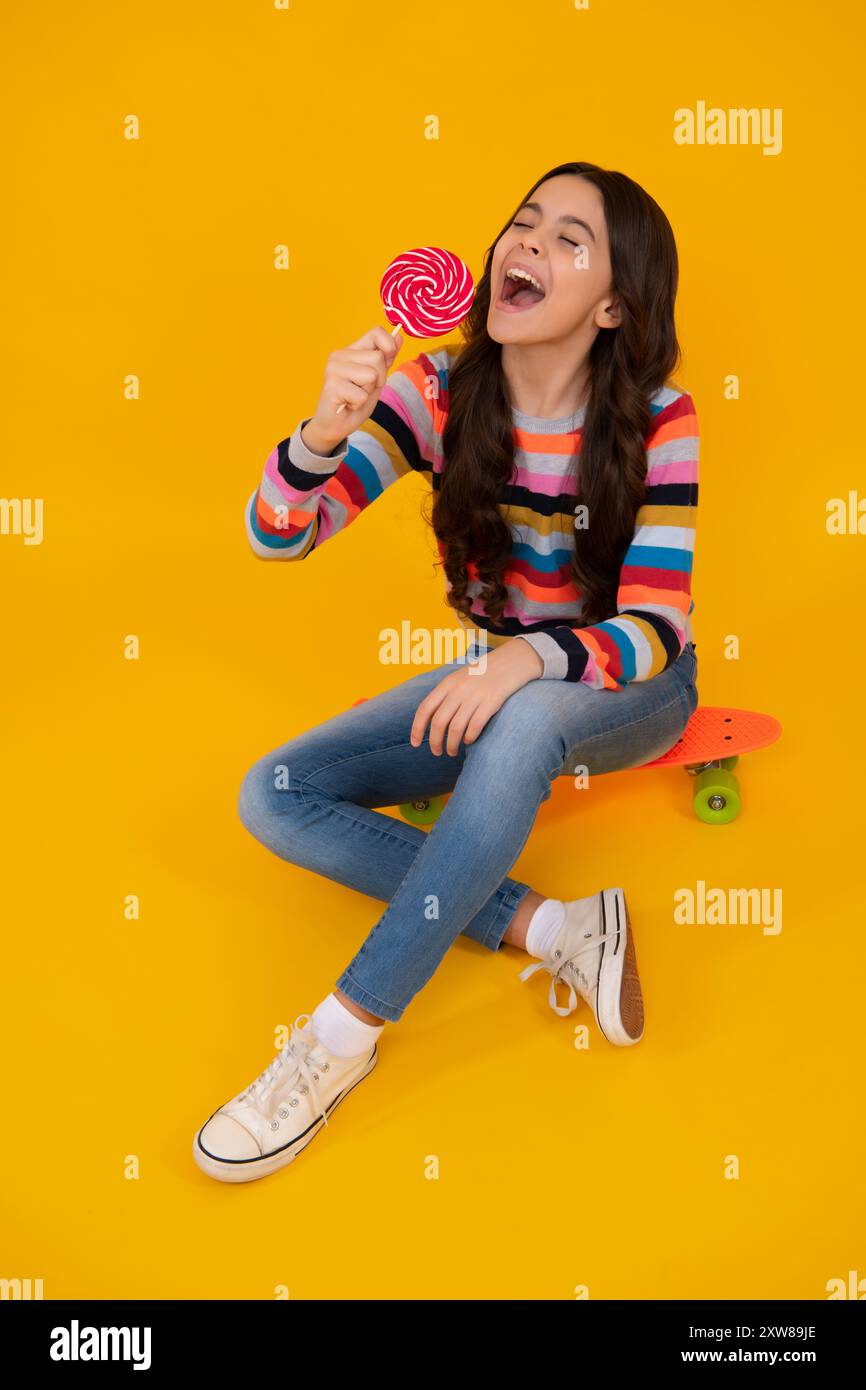 Amazed teenager. Teenager girl with caramel candies on sticks, sweet ...