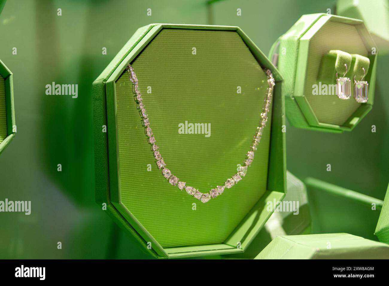 Vibrant green hexagonal display boxes showcase a sparkling diamond ...