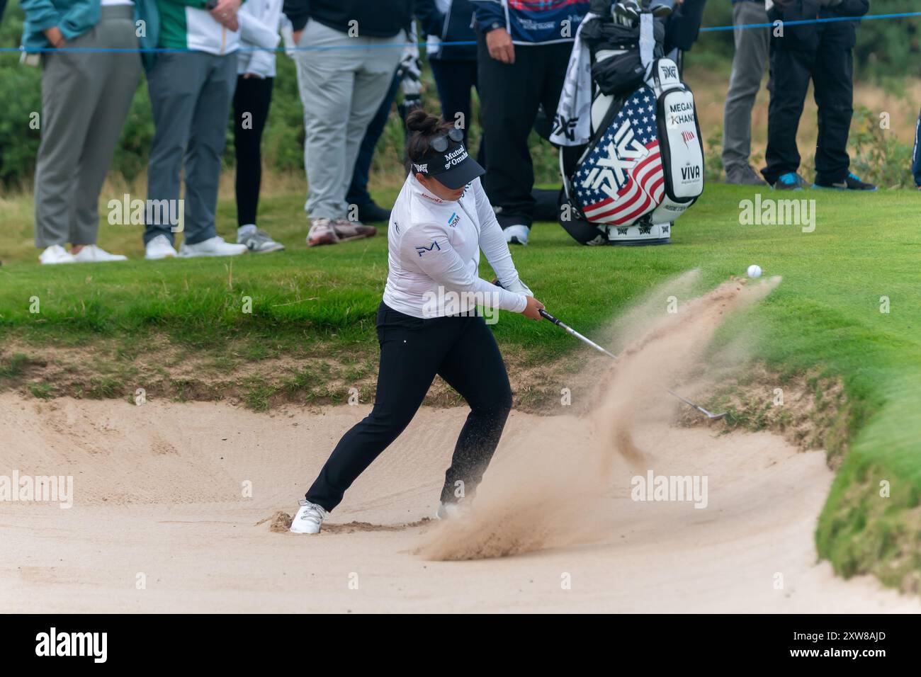 North Ayrshire, Scotland. 18th August 2024. Megan Khang splashing out of a bunker during the ...