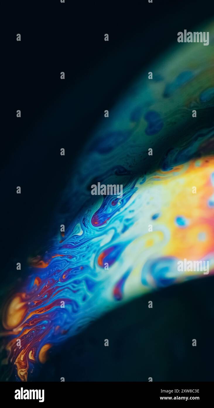 Oil paint mix. Gasoline fluid. Defocused pink orange blue color rainbow ...
