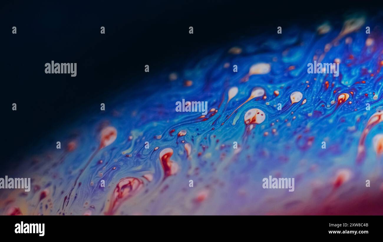 Psychedelic dye. Gasoline fluid. Defocused blue pink orange color ...