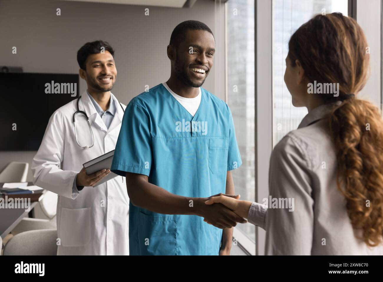 Patient shake hands with young African doctor Stock Photo - Alamy