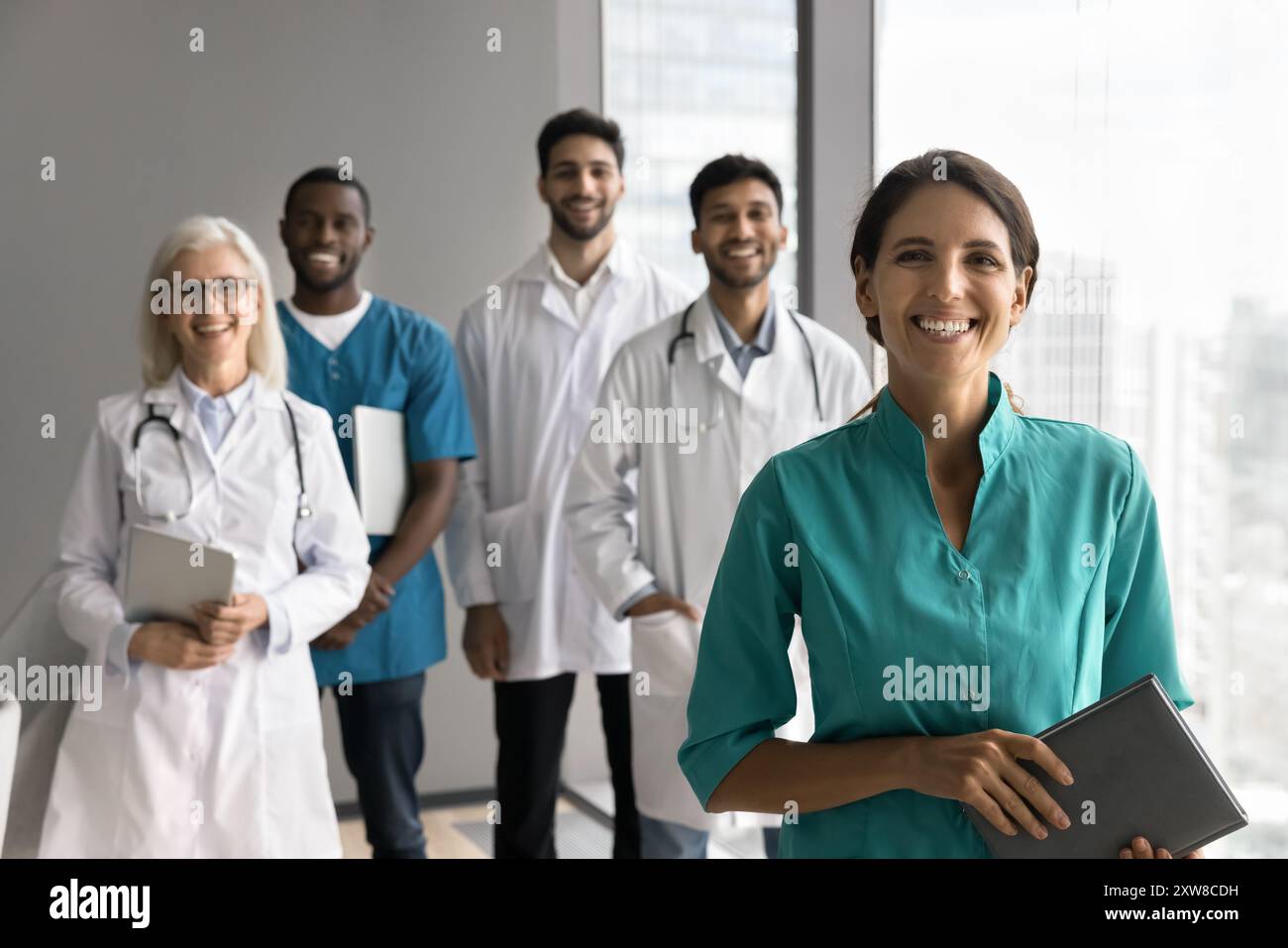 Beautiful Hispanic female internist in medical attire posing with ...