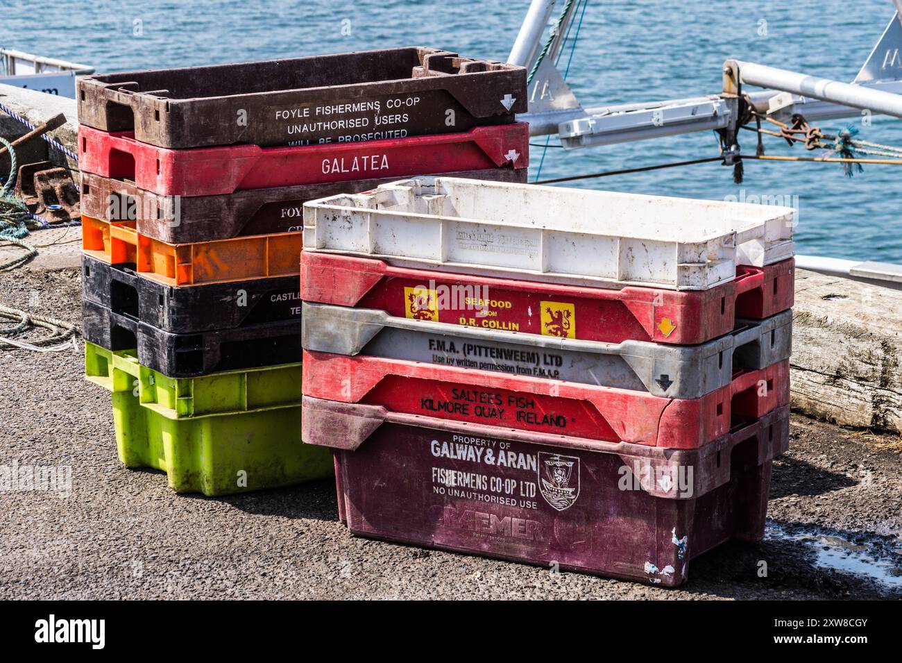 Empty fish boxes on the quayside, Amble, Northumberland, England Stock ...