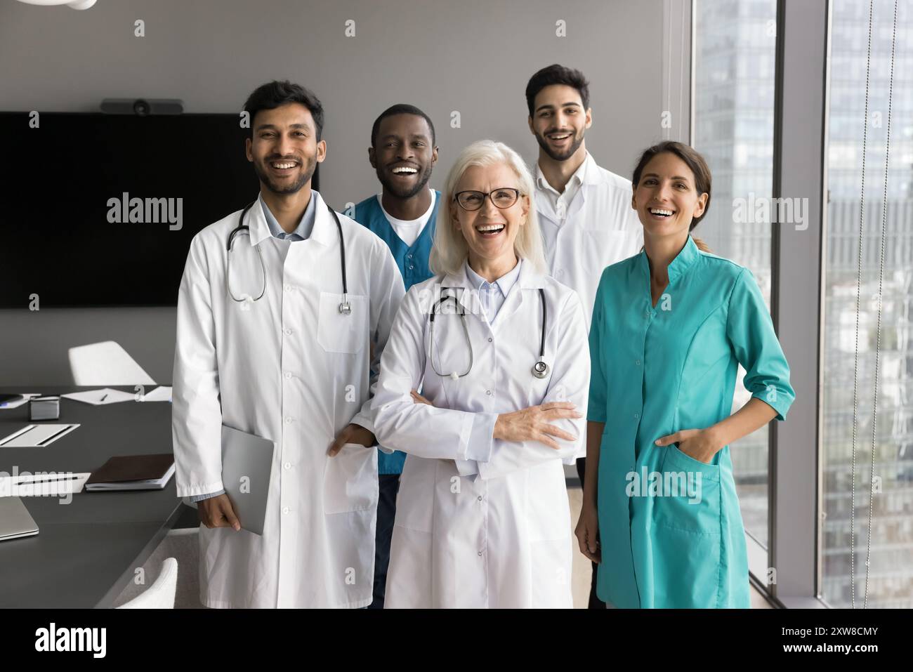 Medicine professionals wear medical attire standing together in modern ...