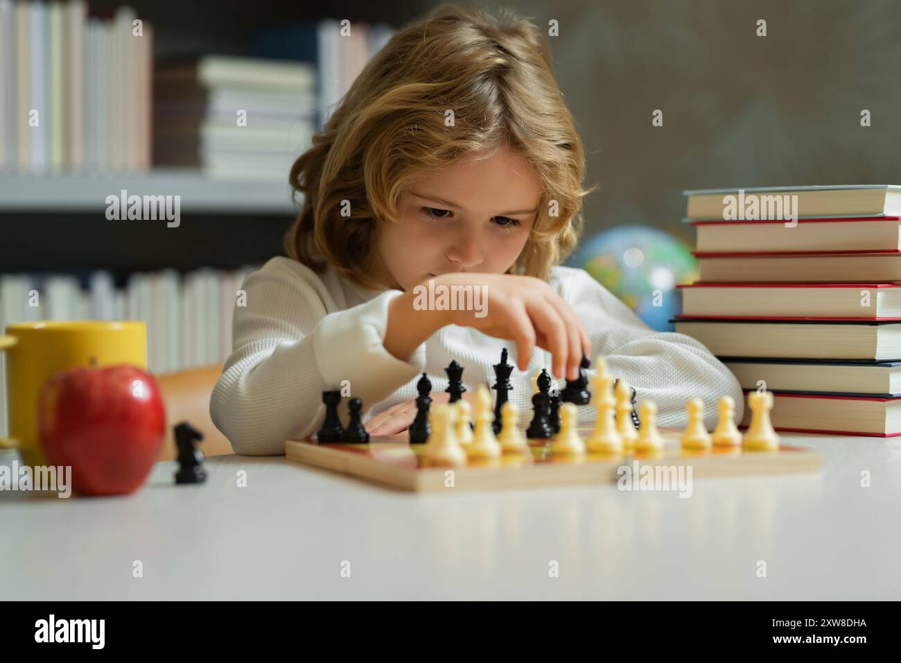 Child playing chess. Clever kid thinking about chess. Logic game for ...