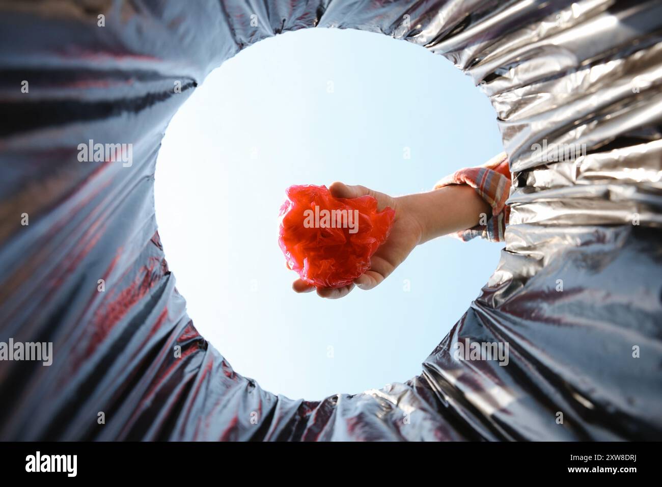Man throwing garbage into trash bin outdoors, bottom view Stock Photo ...