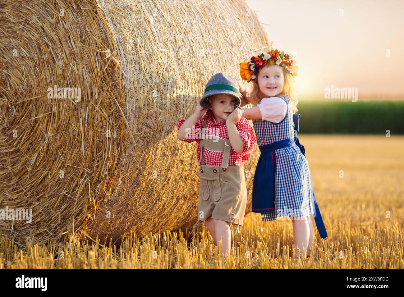 Child in wheat field with bread and pretzel. Oktoberfest time in ...