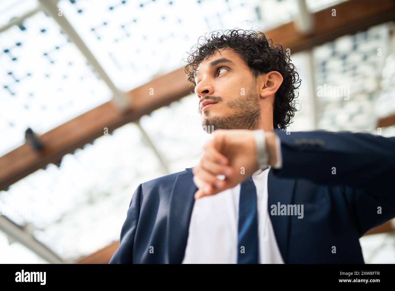 Businessman watching the time in a modern city Stock Photo - Alamy