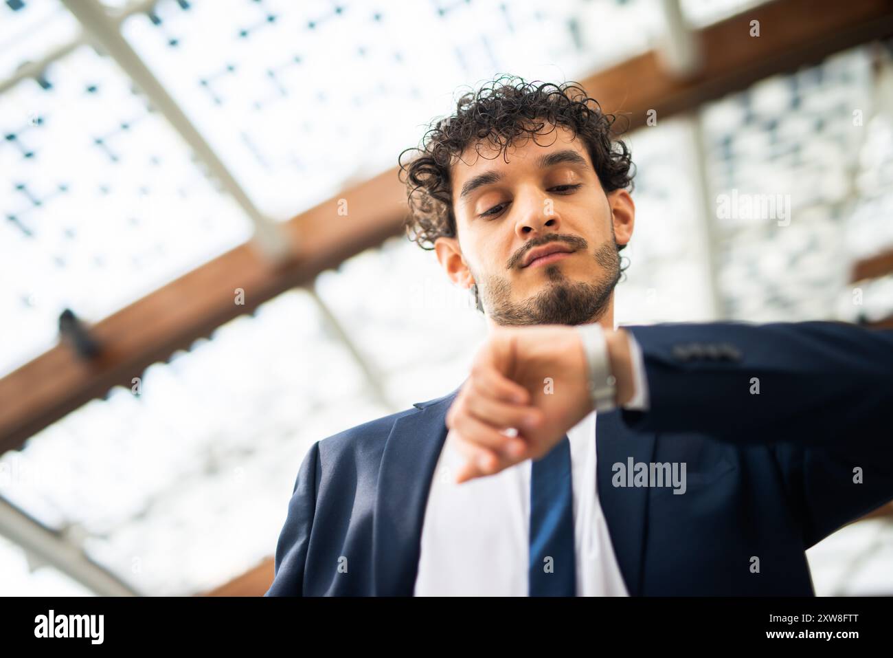 Businessman watching the time in a modern city Stock Photo - Alamy