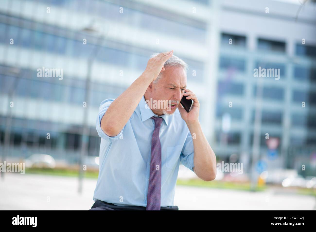 Angry senior business man yelling at the phone outdoor Stock Photo - Alamy
